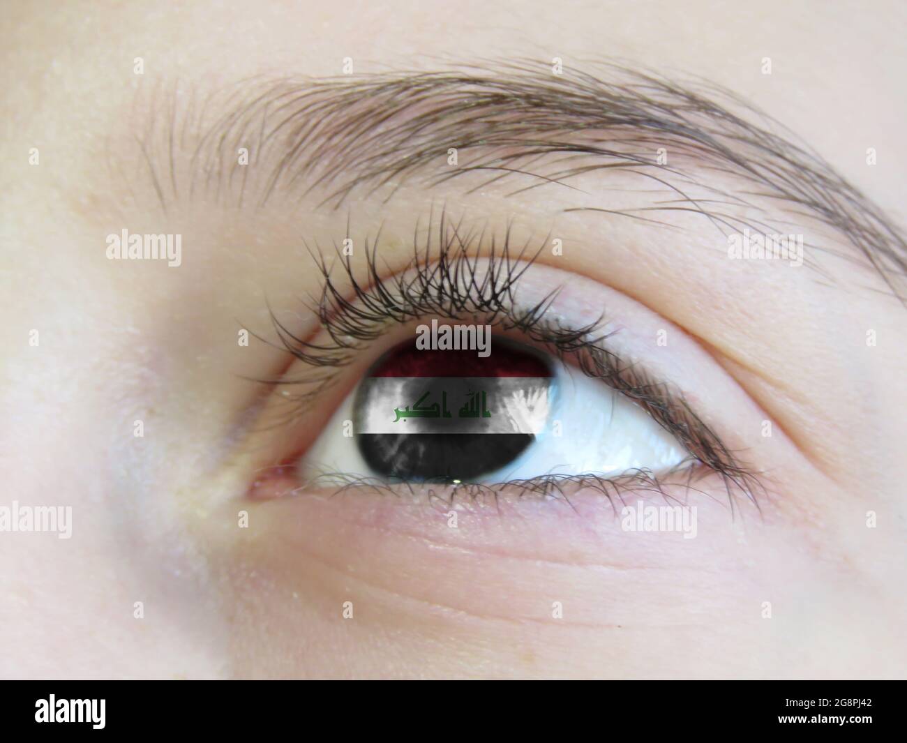 Portrait of a young girl with the color of the eyes of the flag of Iraq ...