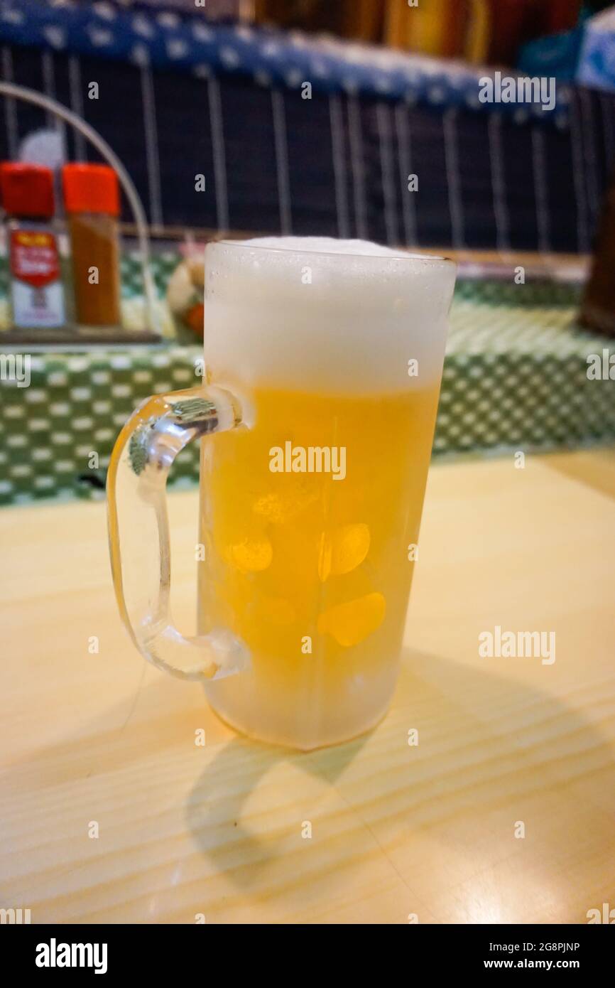 A glass of Japanese beer serve by restaurant Stock Photo - Alamy