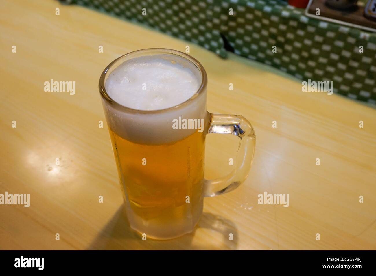 A glass of Japanese beer serve by restaurant Stock Photo - Alamy