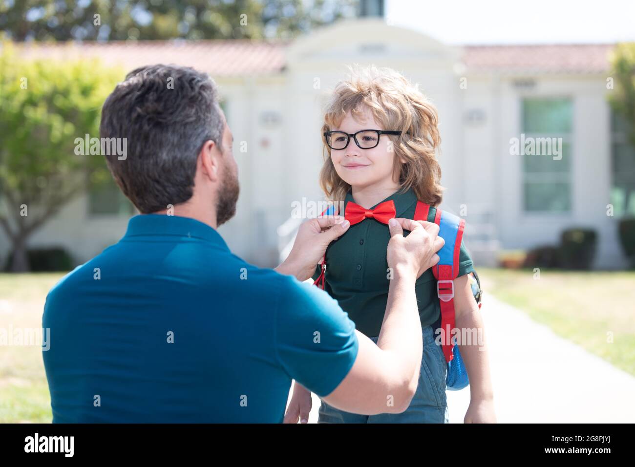 father and son come back from school. happy family value. childhood and ...