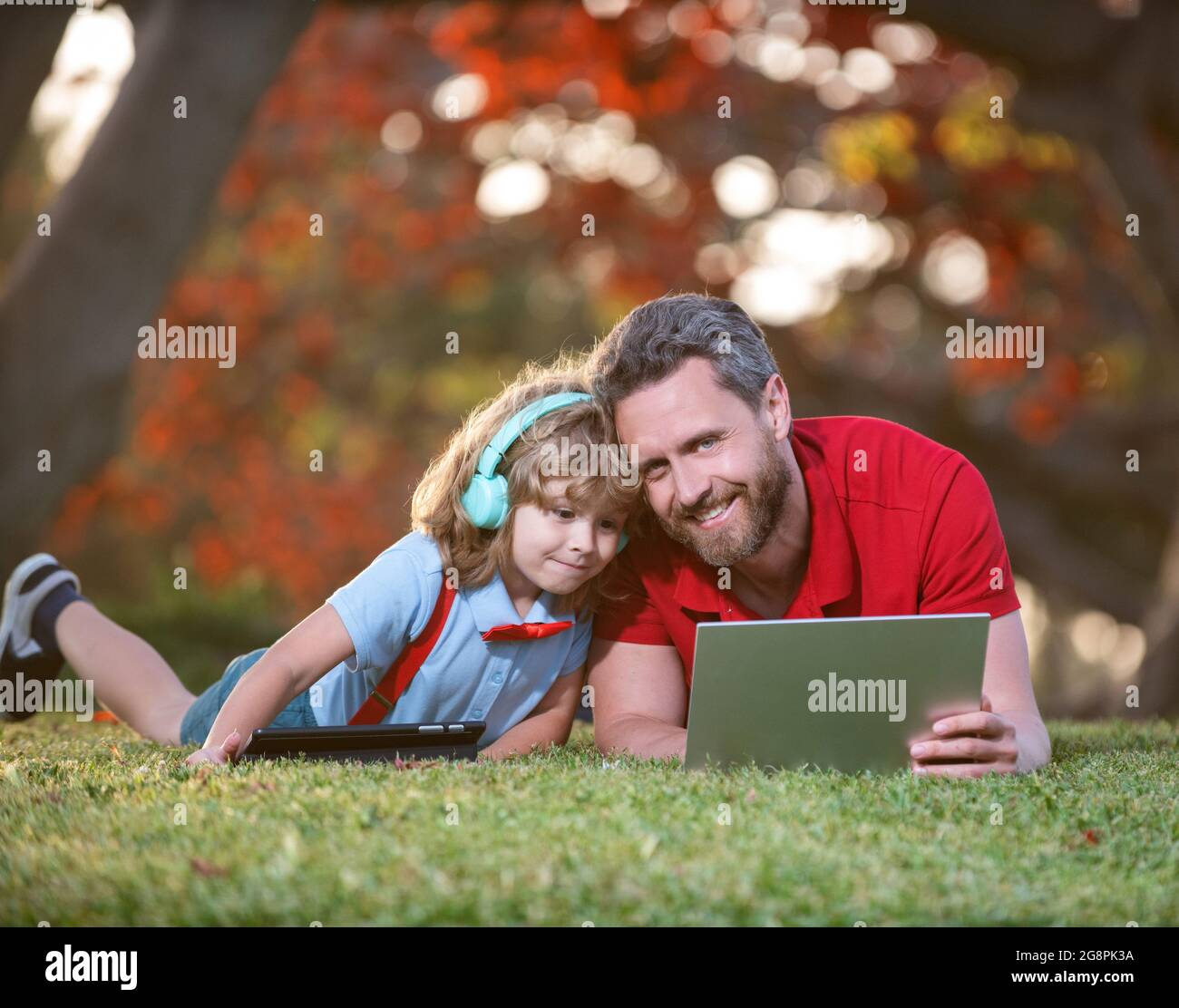 happy family of dad and son use laptop for lesson listen music in ...