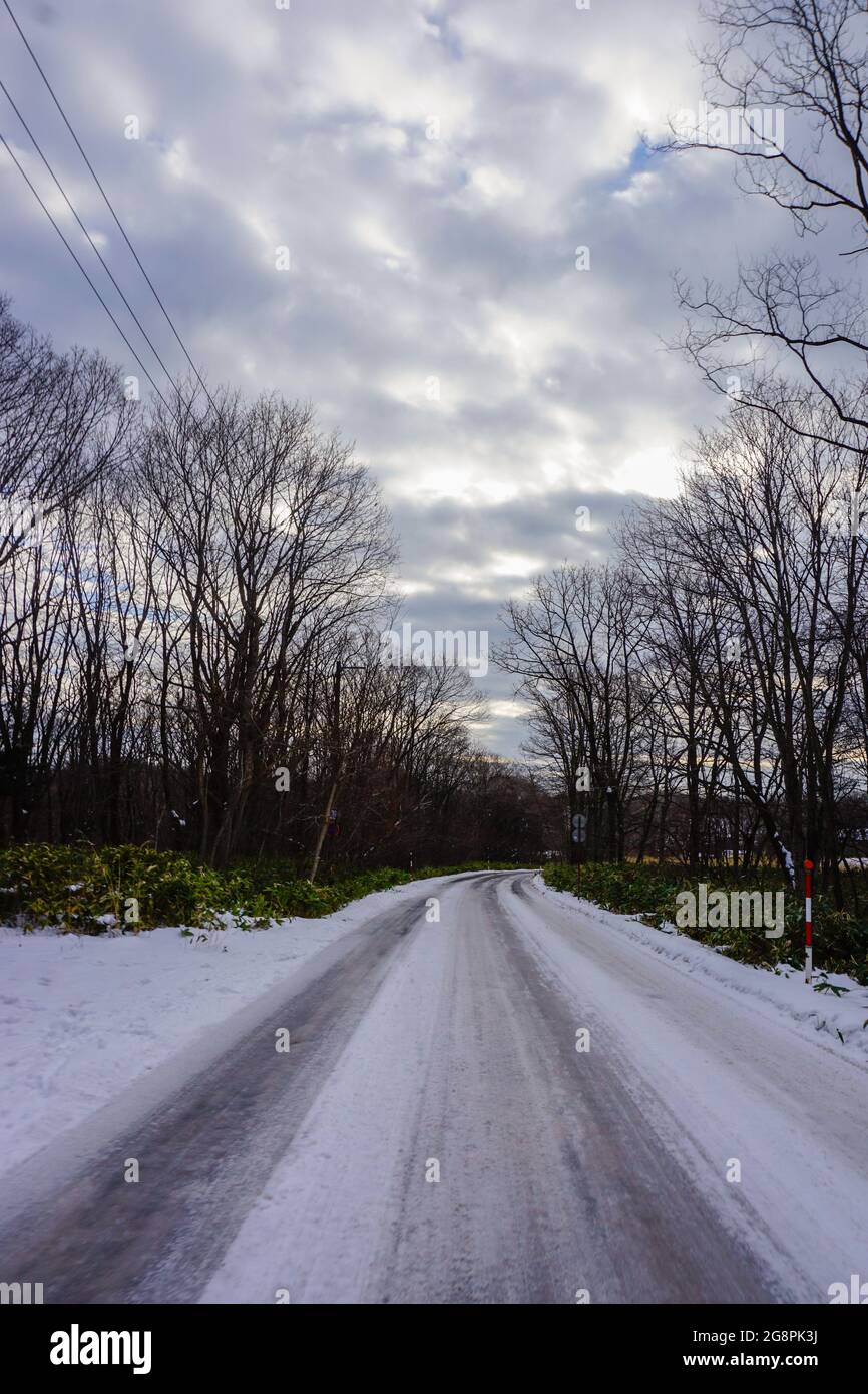 Beautiful Winter landscape and old house with road covered by snow ...