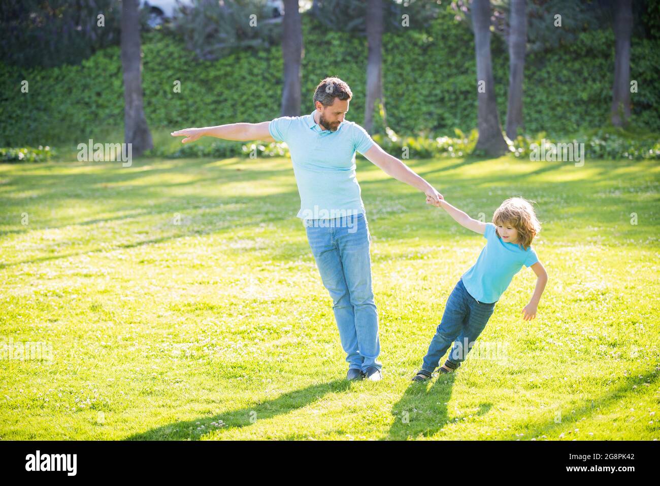 Never stop having fun. Family fun. Father and son play summer outdoors ...