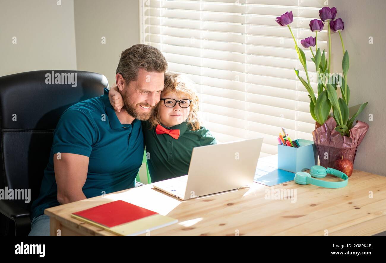 happy daddy or teacher helping his school son kid in glasses study with ...