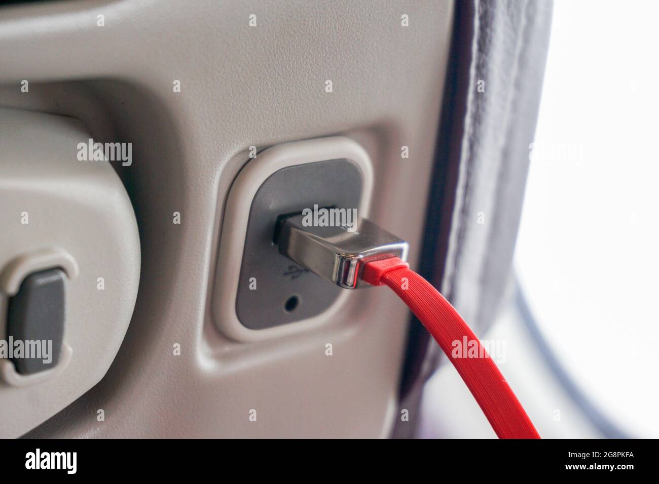 Plug the USB cable on the USB plug in aircraft Stock Photo - Alamy