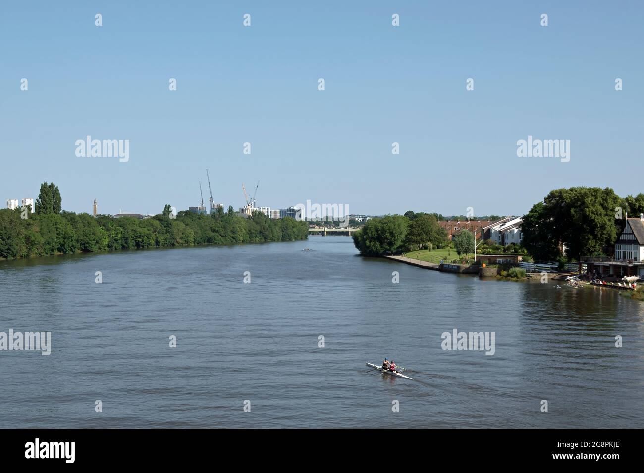 seen from chiswick bridge, two female rowers on a wide stretch of the ...