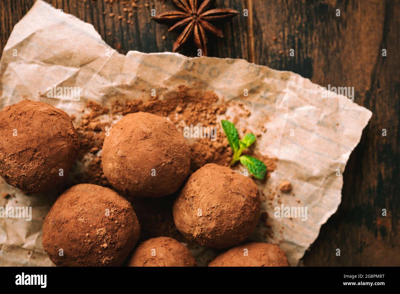 Homemade chocolate truffles on parchment paper, top view Stock Photo ...