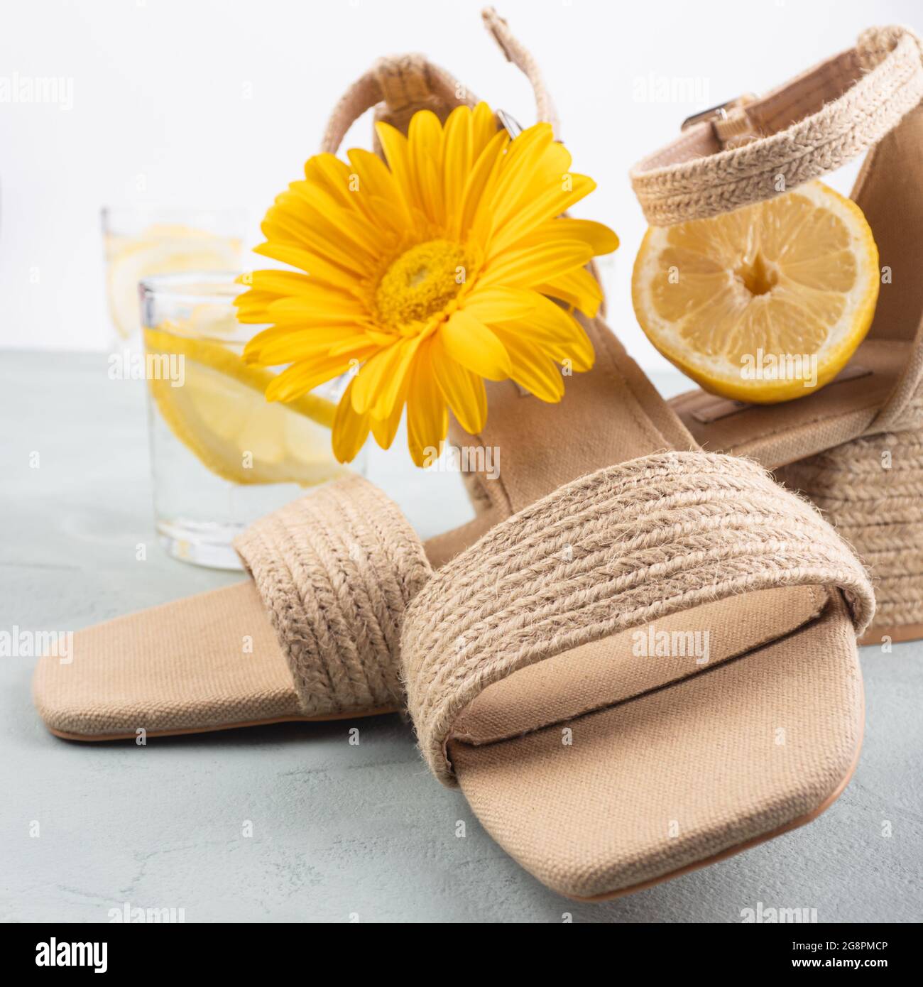 Summer fashion concept with straw sandals on turquoise background with ...