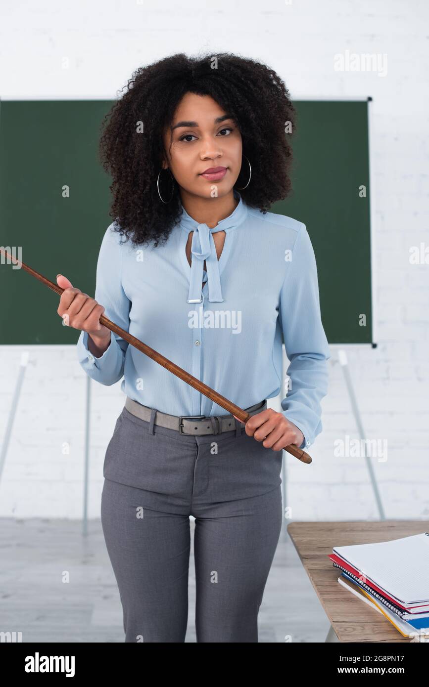 African teacher holding books hi-res stock photography and images - Alamy