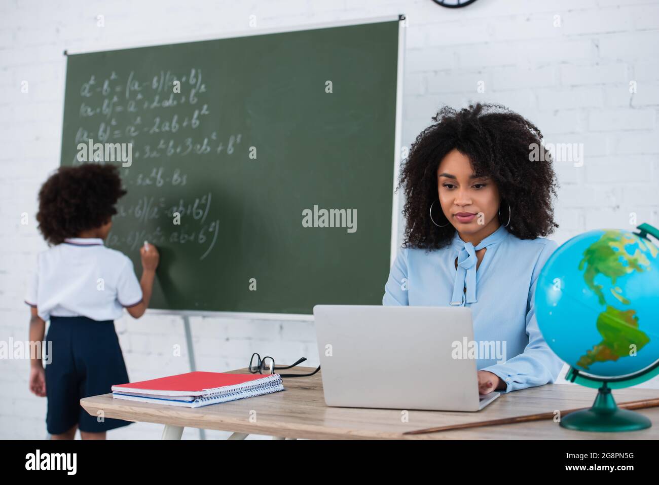 Teacher using laptop pupil hi-res stock photography and images - Alamy