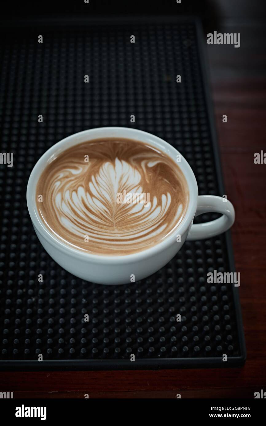 Selective focus cup of hot latte art coffee,focus at white foam Stock ...