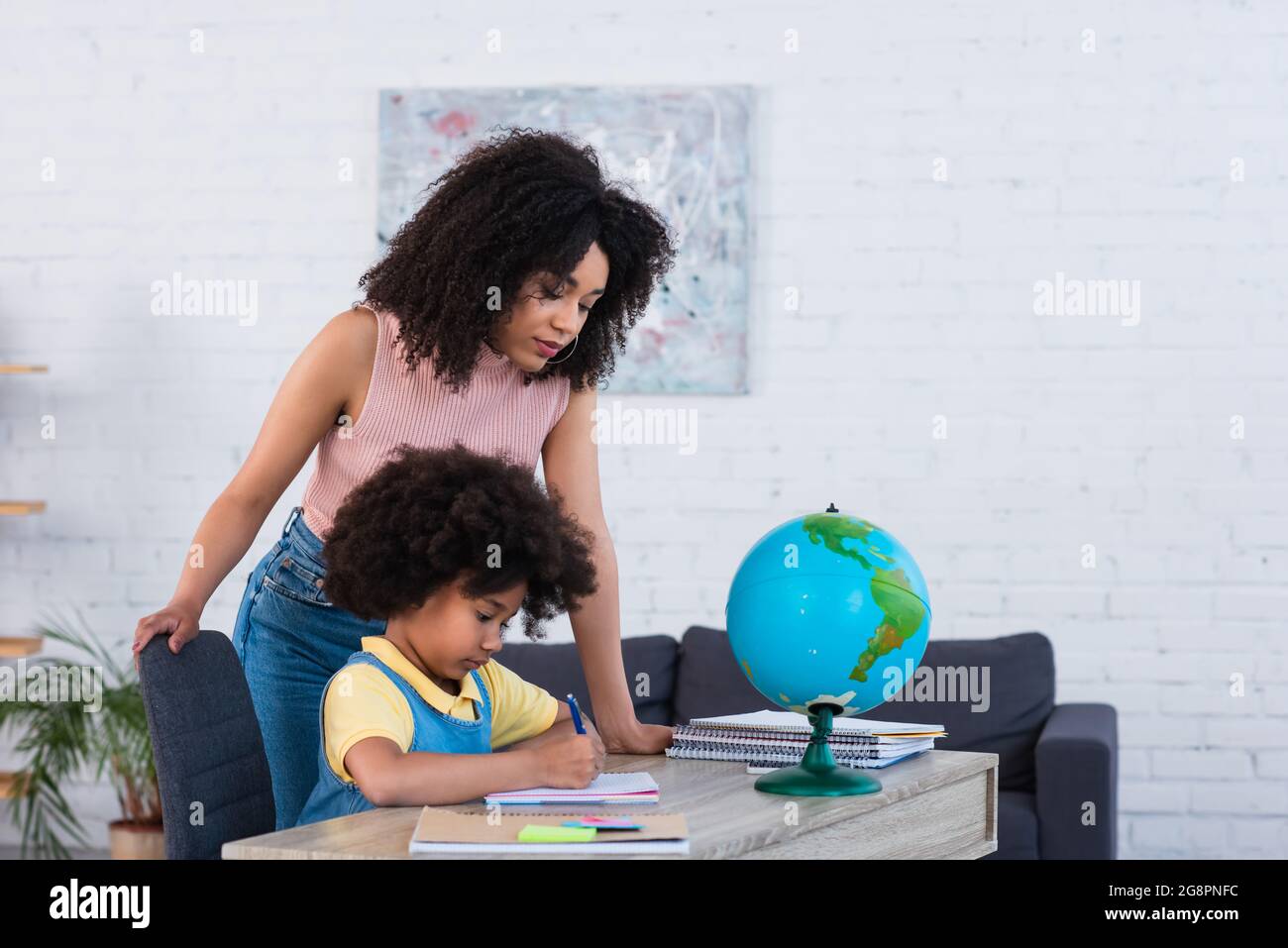 Mom helping daughter homework schoolwork home hi-res stock photography ...