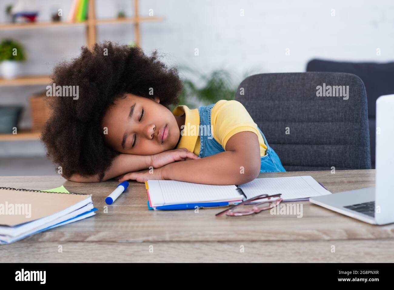 African american kid sleeping near notebooks at home Stock Photo - Alamy