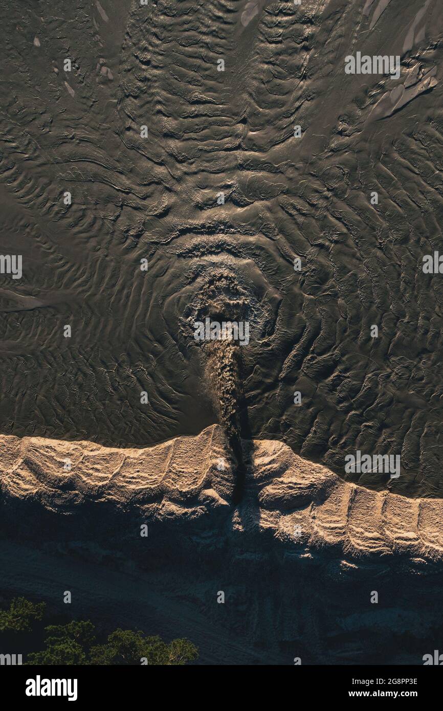 Flow of dirty water with sand during the extraction of sand. Waves ...