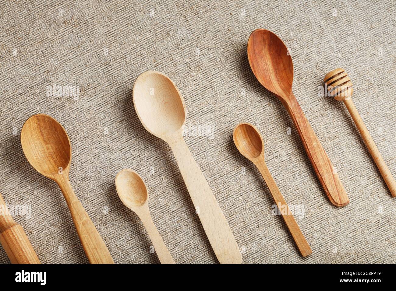 Wooden spoons made of natural wood on burlap fabric as a craft. Natural ...