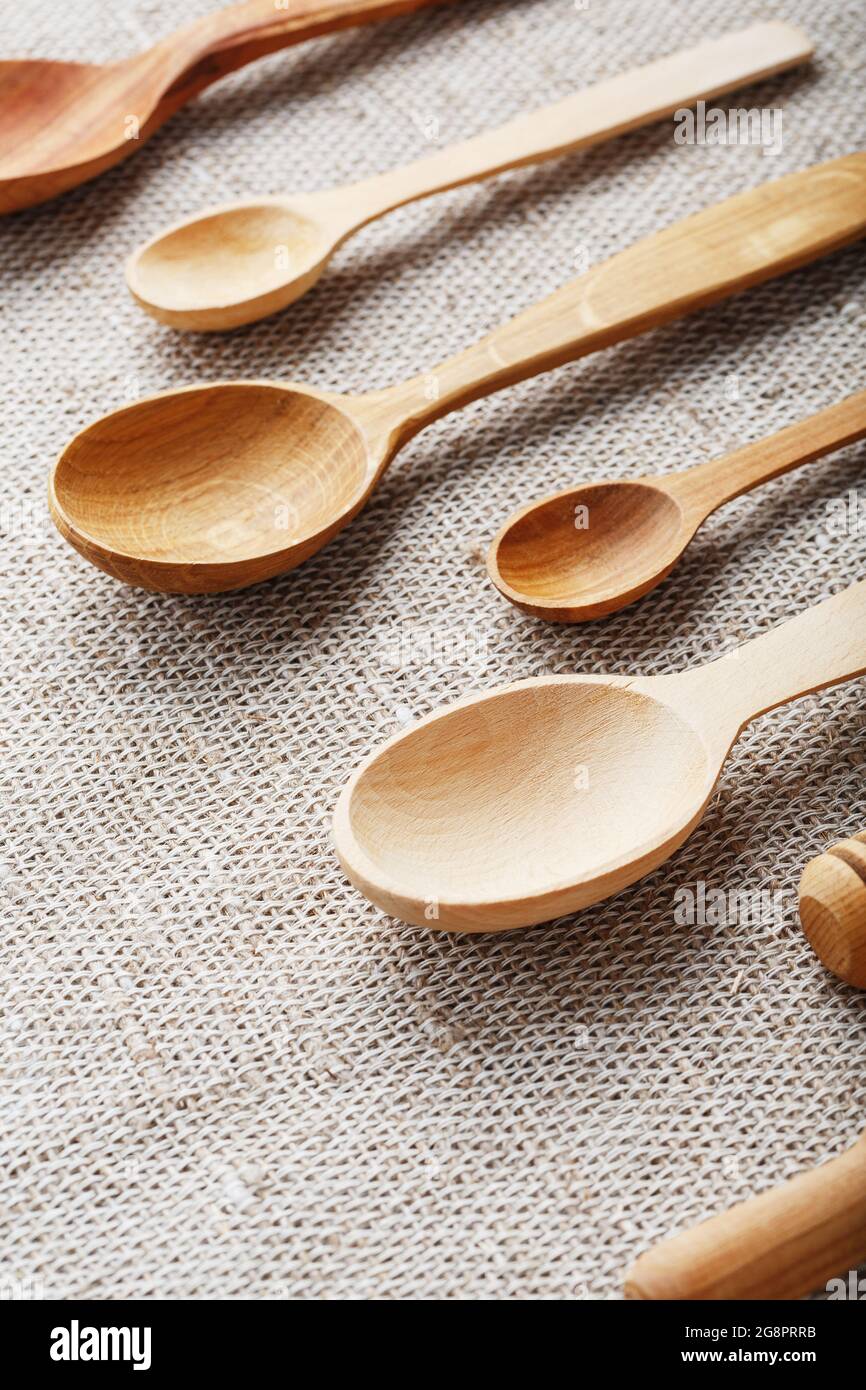 Wooden spoons made of natural wood on burlap fabric as a craft. Natural ...