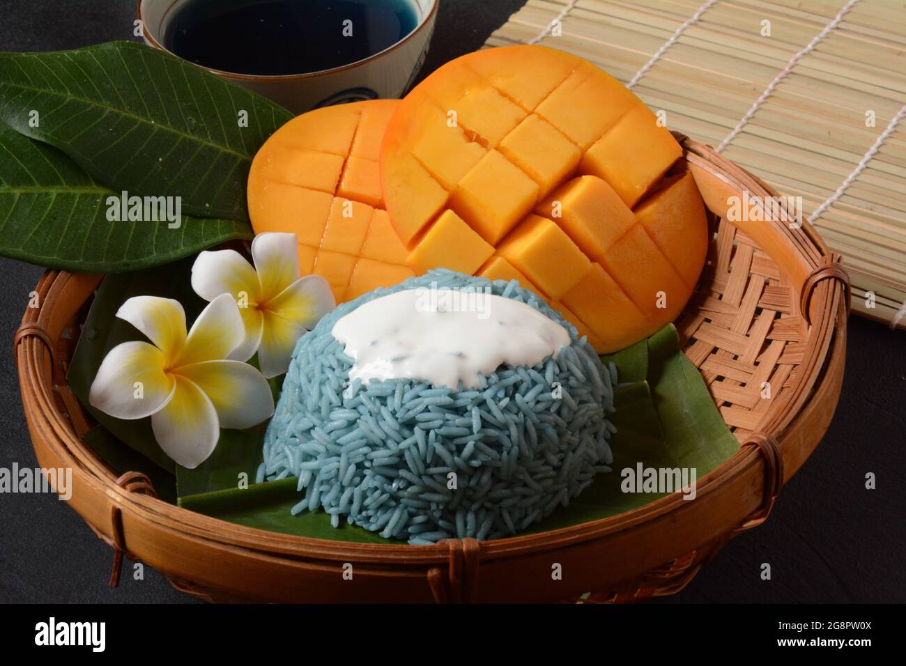 Mango and sticky rice, Thai sweet dessert, colored with butterfly pea ...