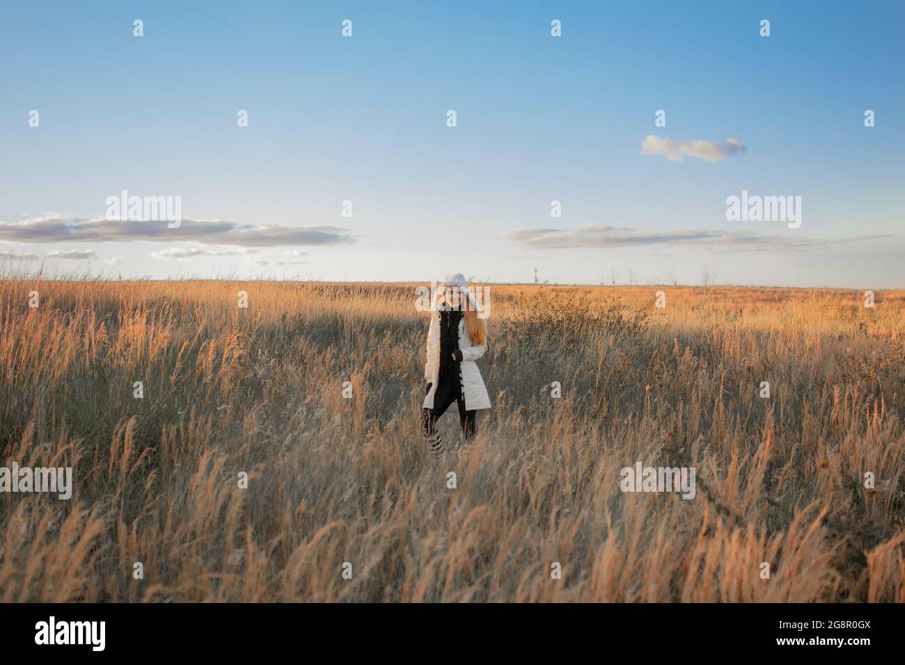 Young blonde-hair Hispanic female having a nice time in the field at ...