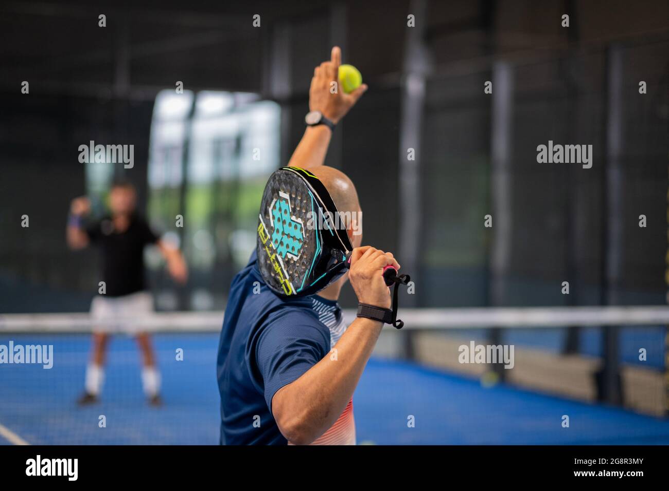 Monitor teaching padel class to man, his student - Trainer teaches boy ...