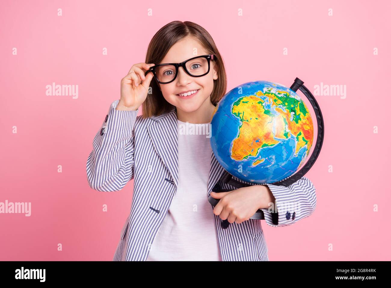 Portrait of attractive cheerful girl holding in hands globe lecture ...