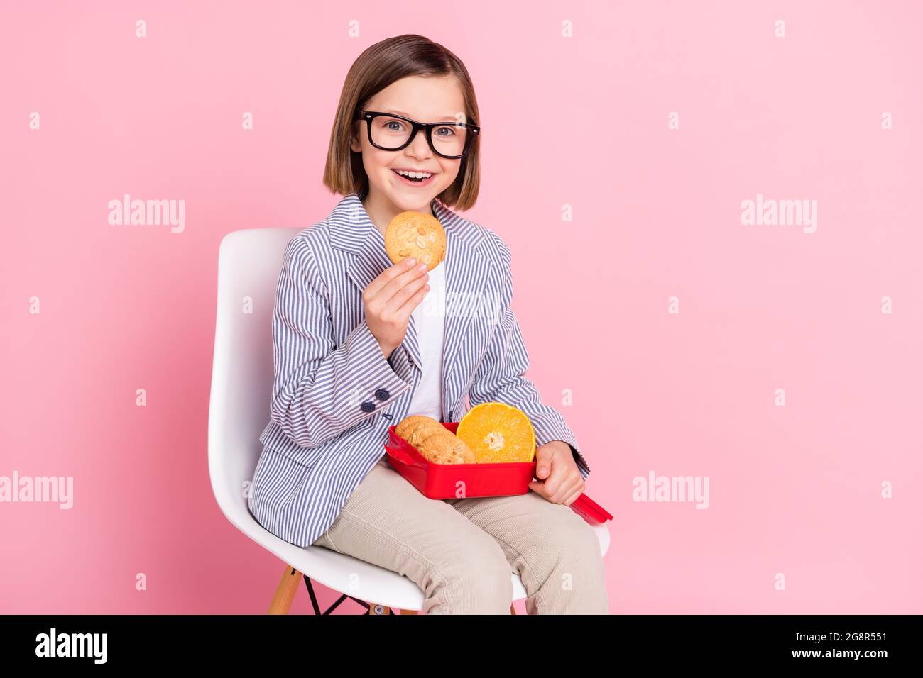 Portrait of attractive cheerful girl eating tasty yummy domestic lunch ...