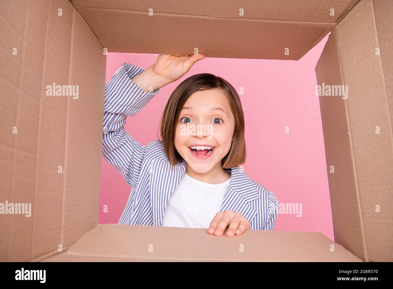 Portrait of attractive trendy cheerful girl opening box package gift ...