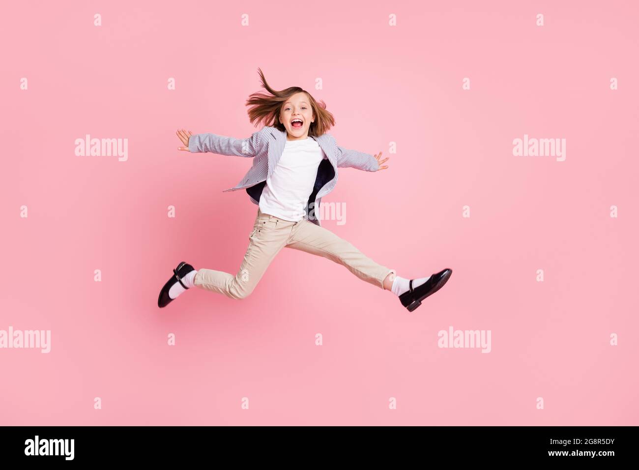 Full body photo of little girl jump wear striped blazer trousers shoes ...