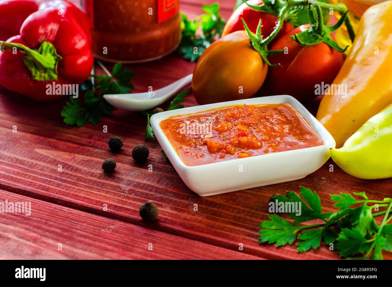 hot sauce adjika with fresh vegetables for cooking Stock Photo - Alamy