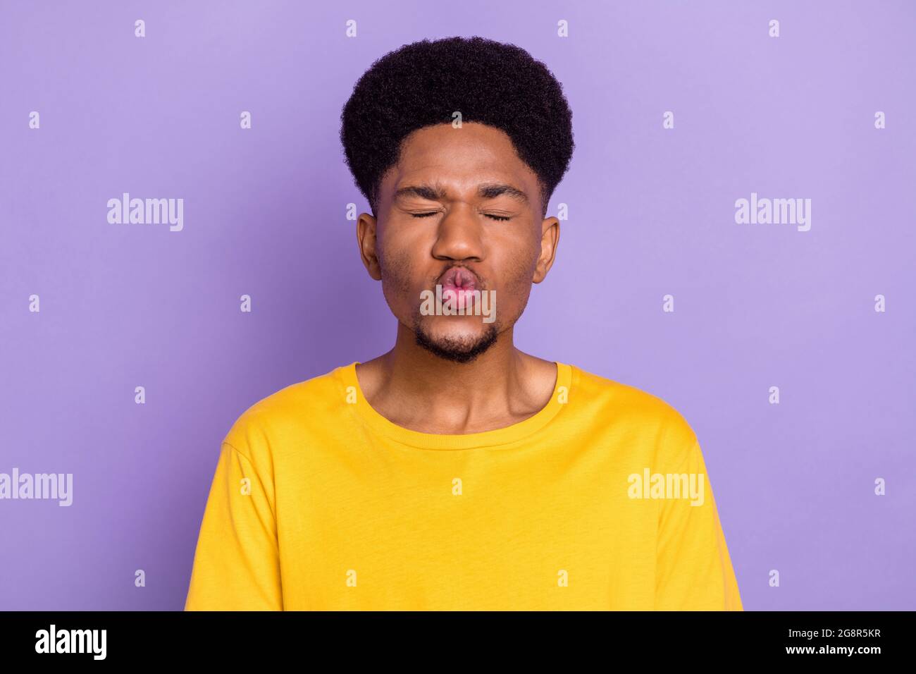 Portrait of attractive affectionate dreamy guy sending you air blow ...