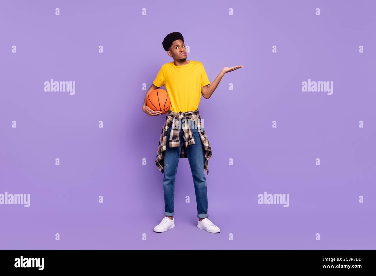 Full length body size view of attractive confused guy holding ball ...