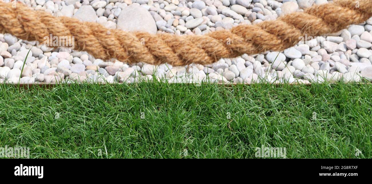 Coarse rope with white gravel background and grass below Stock Photo ...