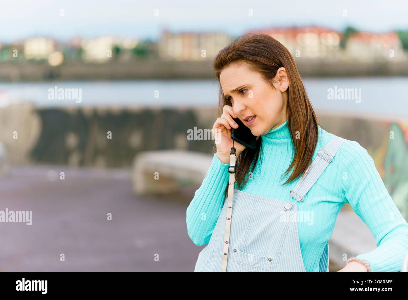 Millennial young adult woman having a conversation on the smartphone ...