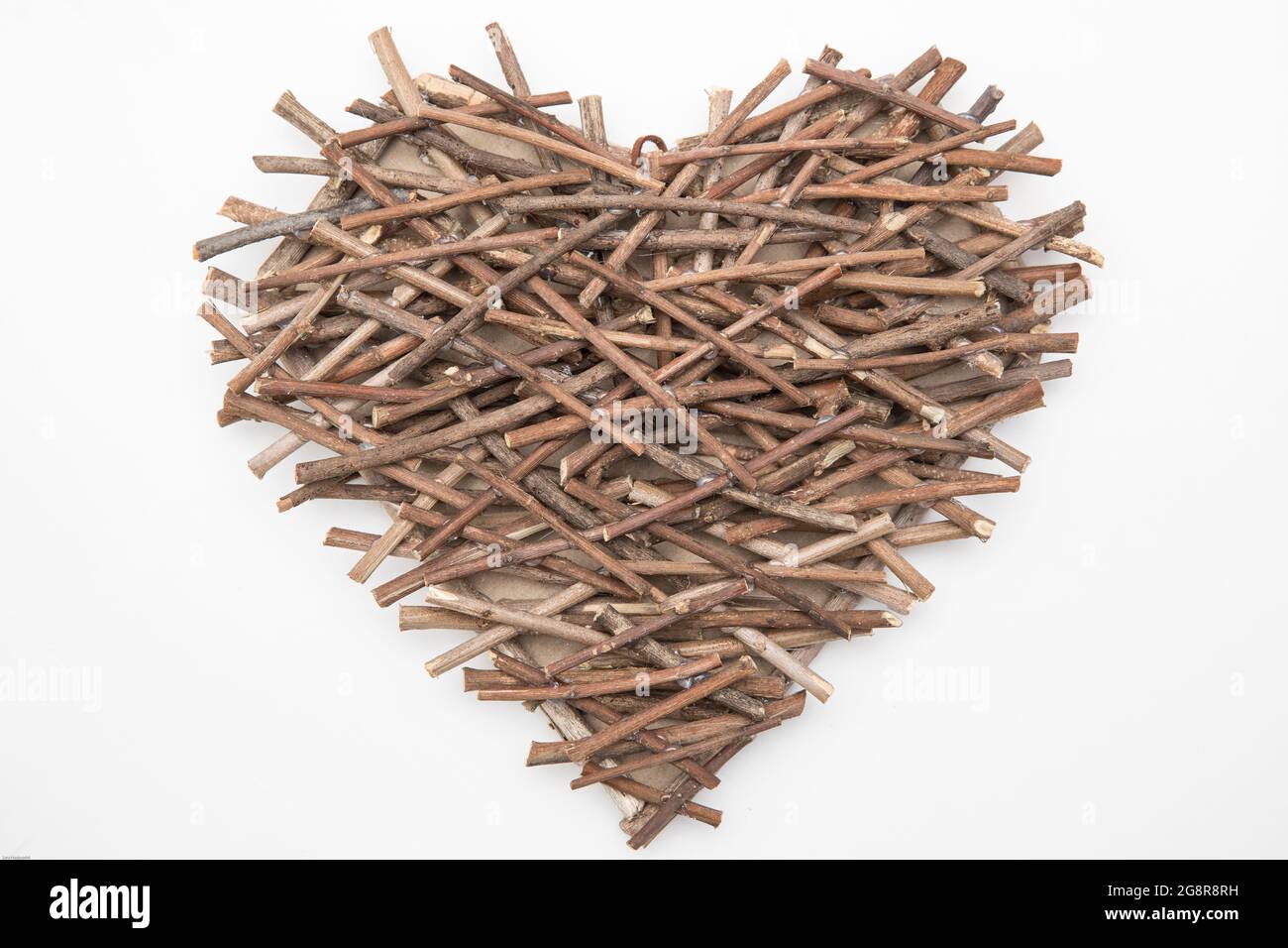 Heart shape handcraft made from small dry branch, on white background ...