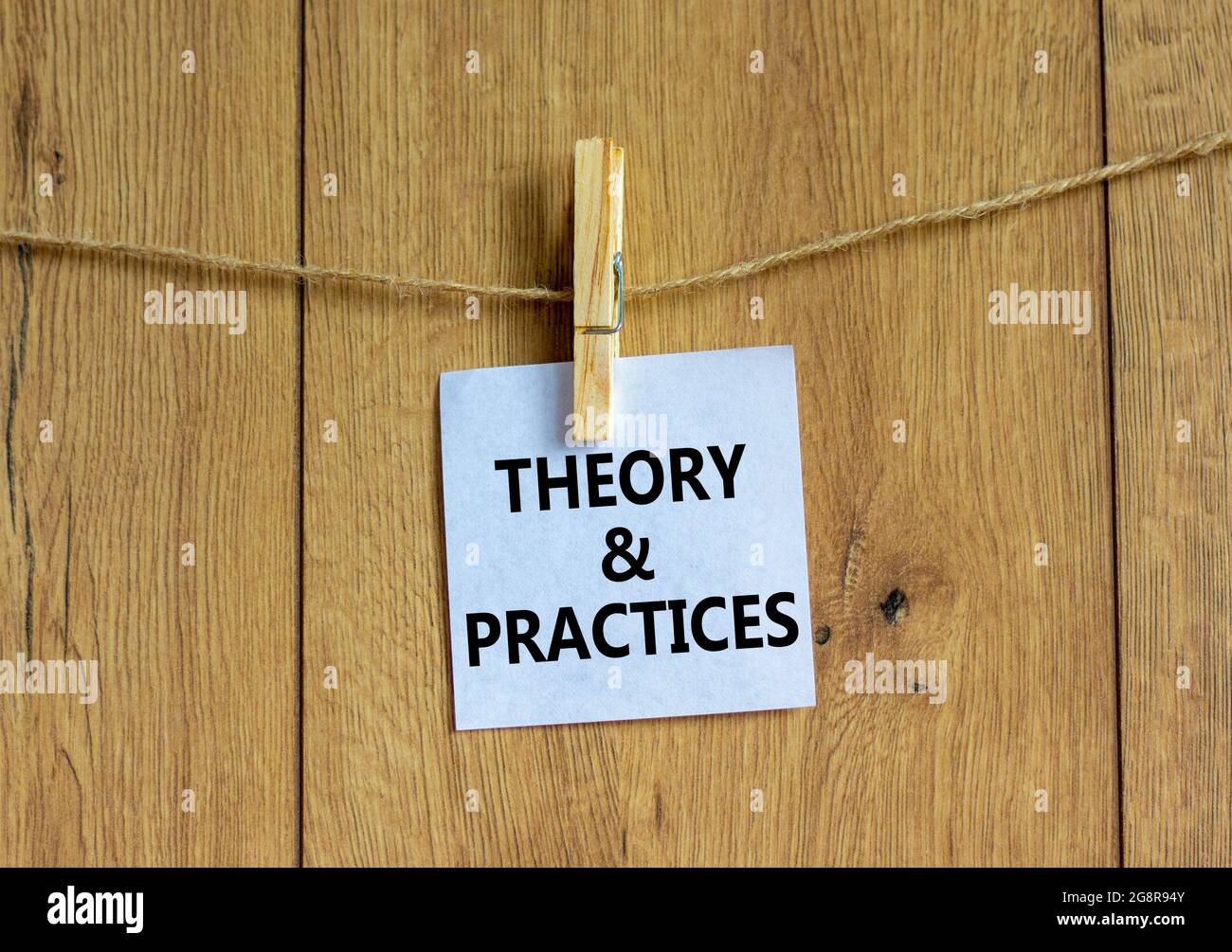 Theory and practice symbol. White paper with words 'Theory and practice ...