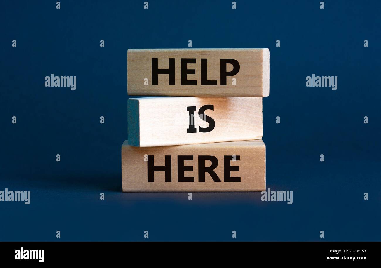 Help is here and support symbol. Wooden blocks with words 'Help is here ...