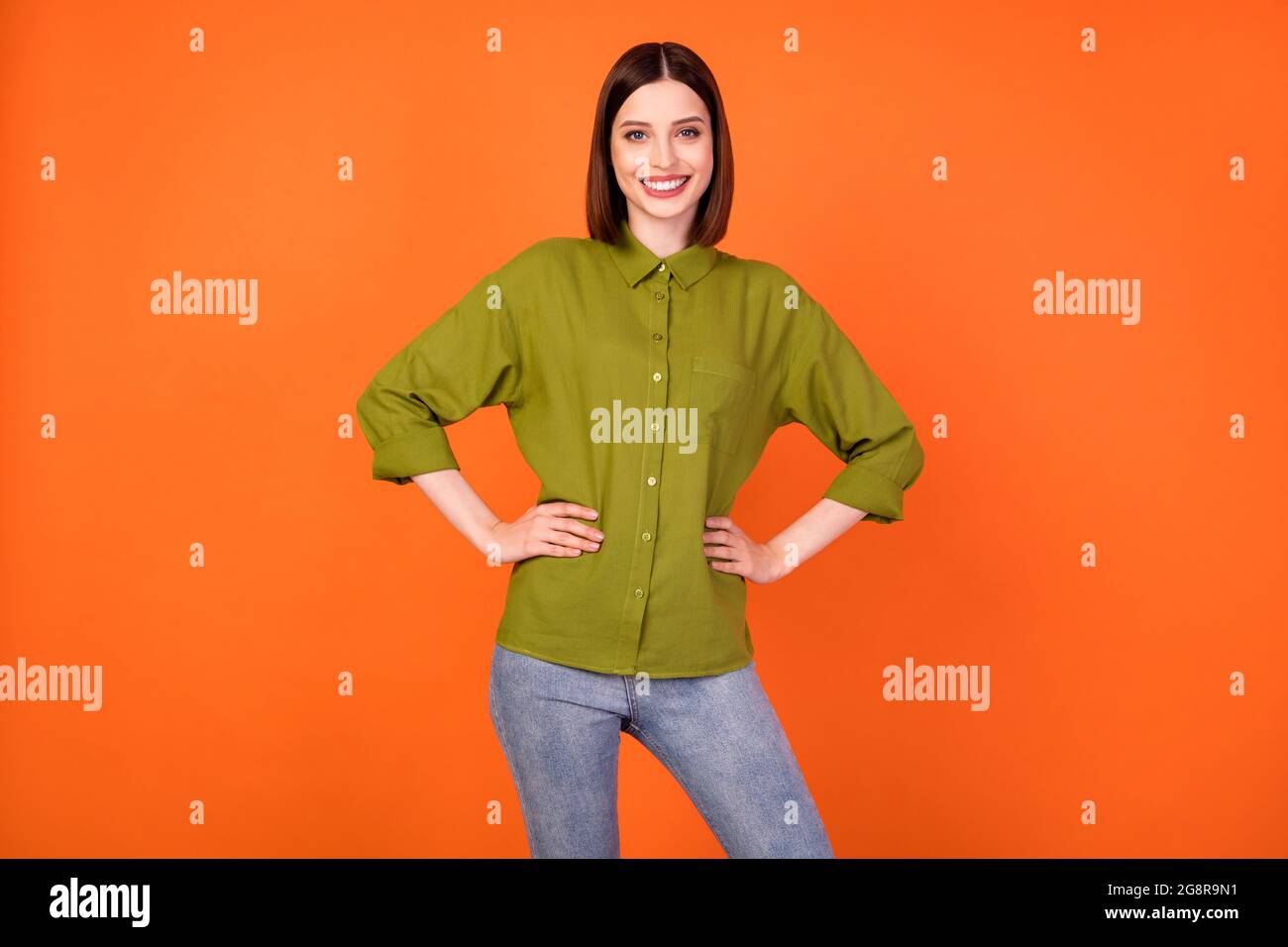 Photo of lovely brunette millennial lady stand wear khaki shirt jeans ...