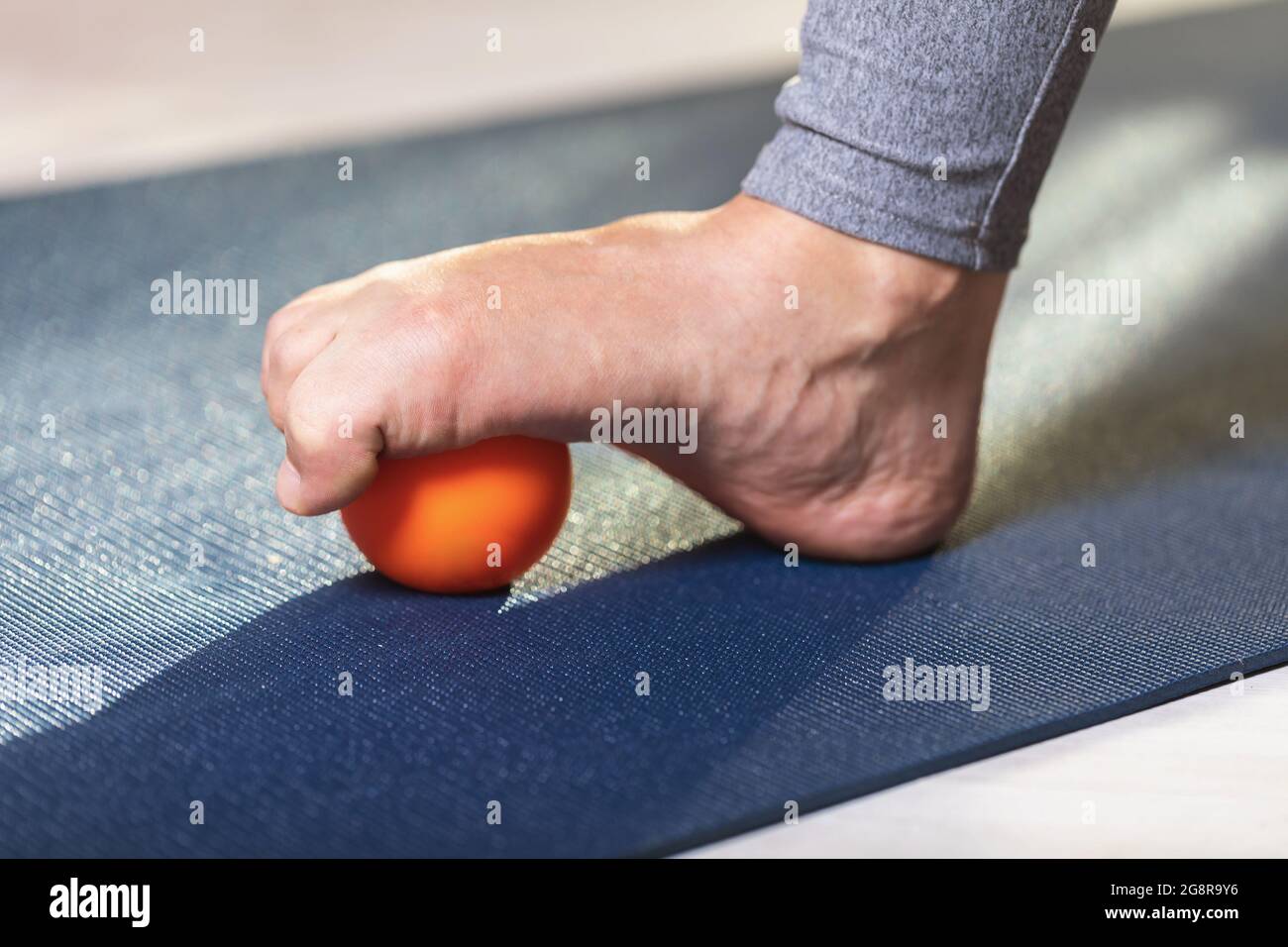 Myofascial relaxation of foot muscles with massage ball on gymnastic ...
