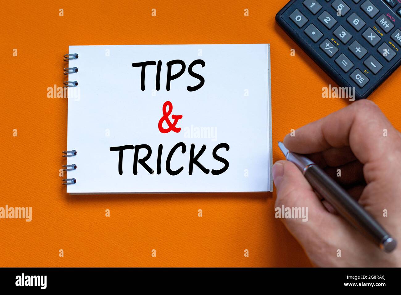 Tips and tricks symbol. Businessman writing words 'Tips and tricks' on ...