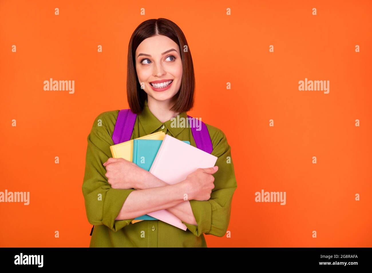 Photo of smart brunette lady hug books look empty space wear bag shirt ...