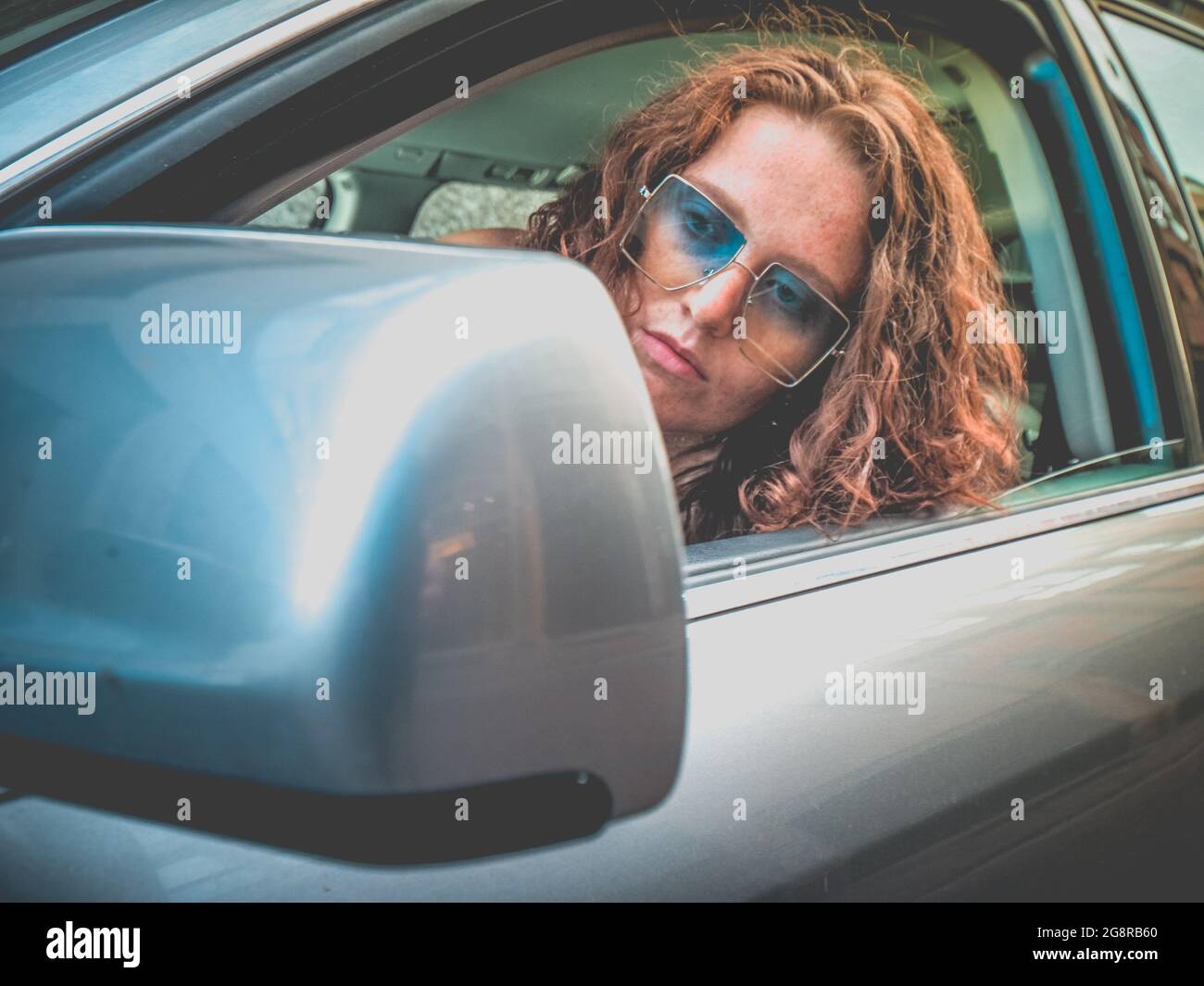 Attractive Italian woman driving a car Stock Photo - Alamy