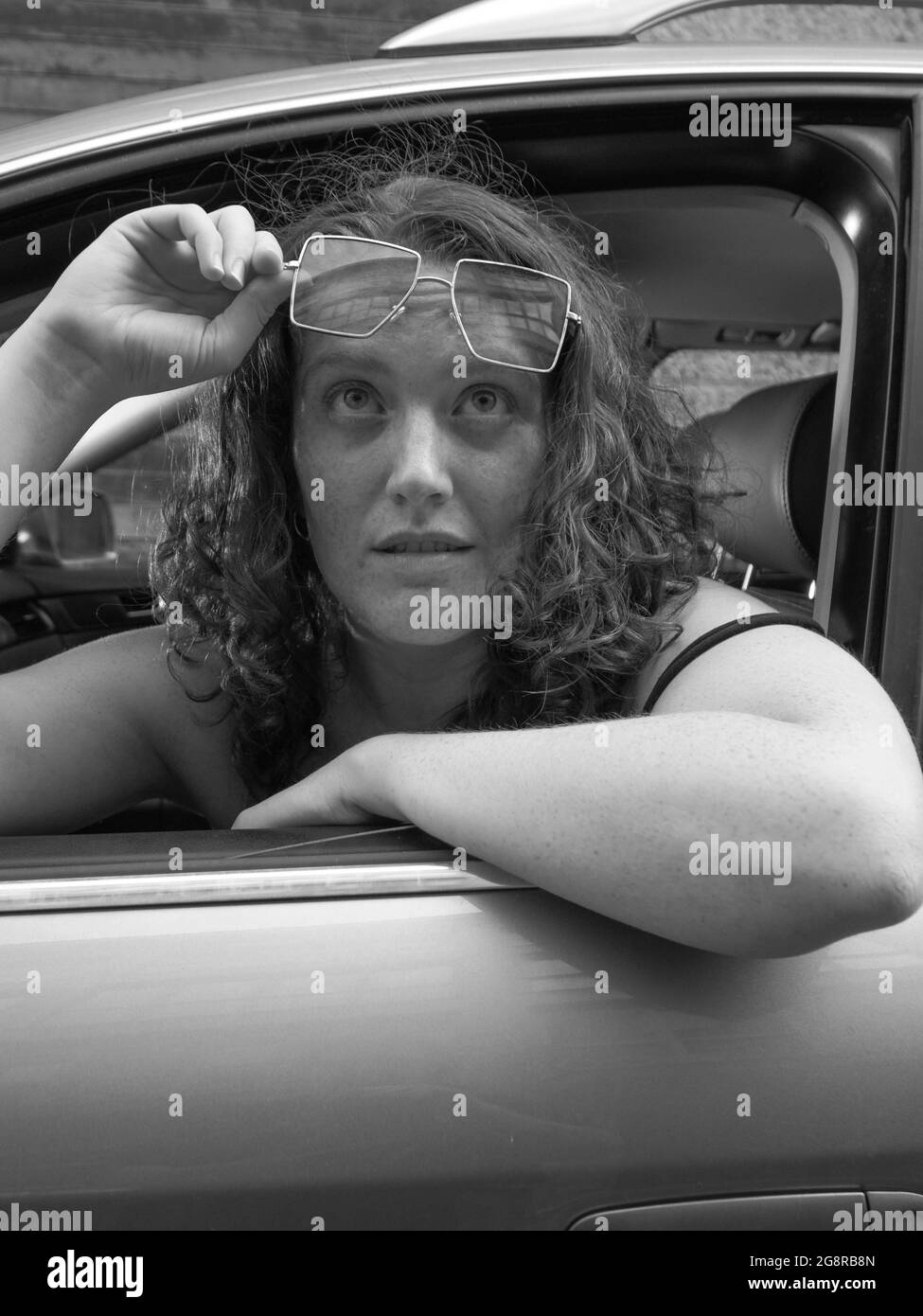 Shallow focus of an Italian woman looking outside from a window of a ...
