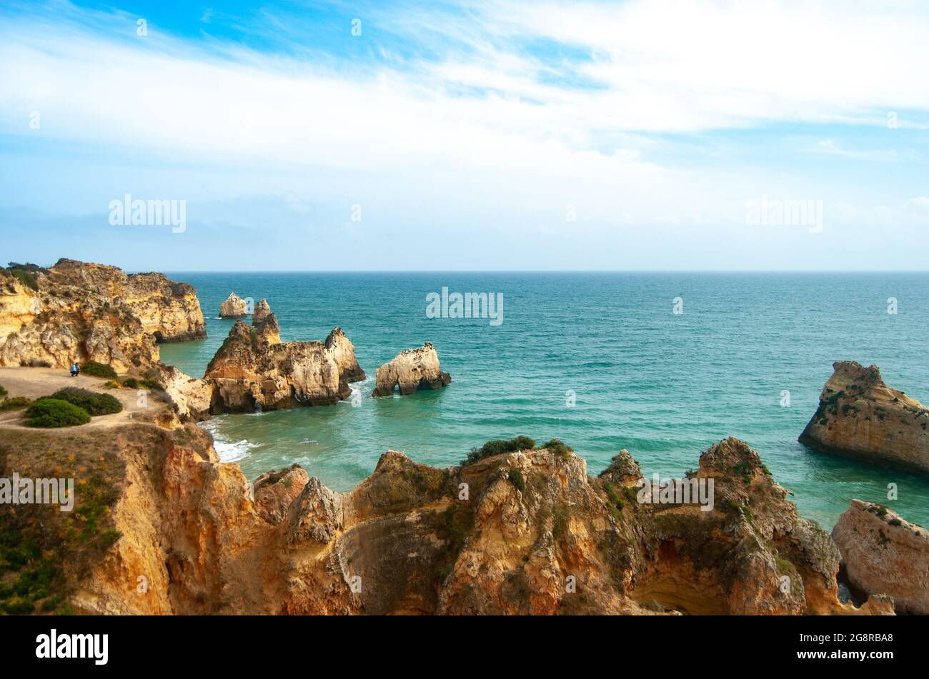 A view of cliffs meeting turquoise water at the coastline of Atlantic ...