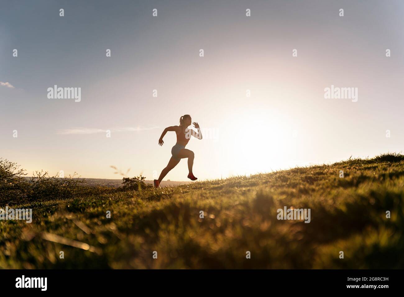 Unrecognized active woman with sports clothes running in the park and ...