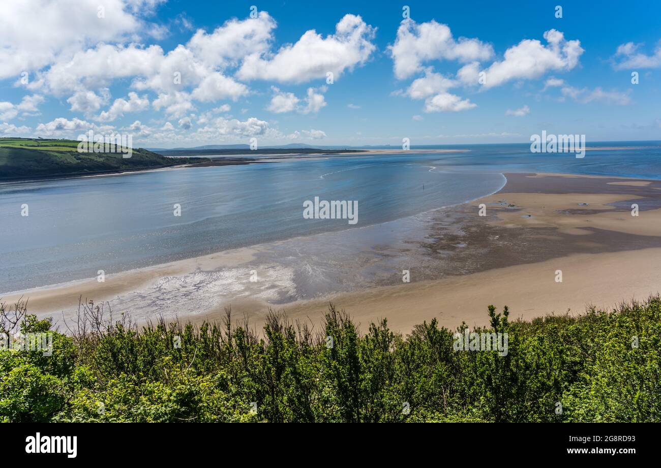 A panoramic shot of LLansteffan beach with clear blue water in southern ...