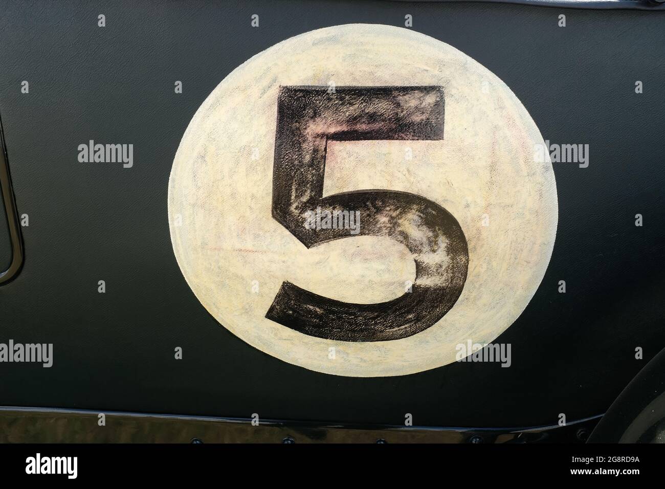July 2021 - Faded number 5 of the door plate of a classic Bentley race ...