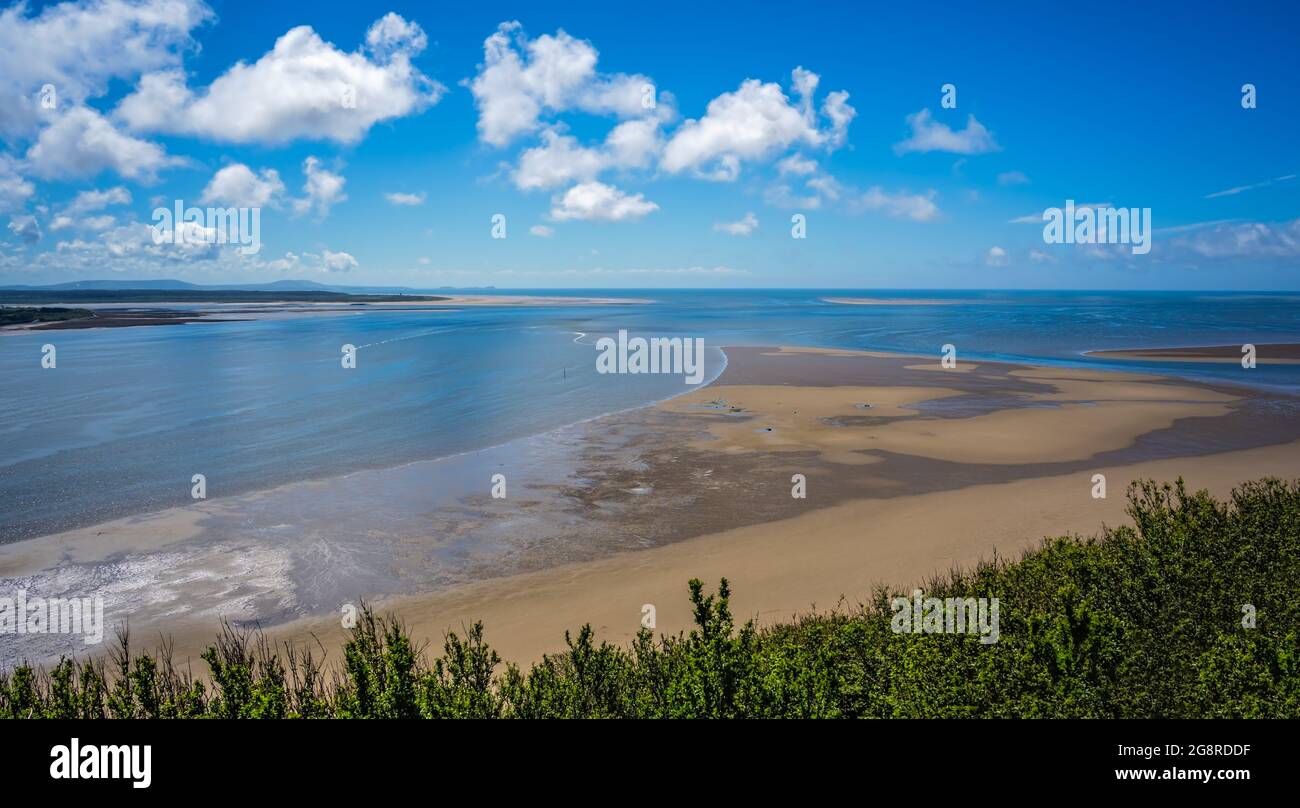 A panoramic shot of LLansteffan beach with clear blue water in southern ...