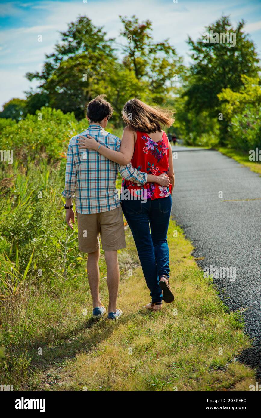 Couple walking together down a path Stock Photo - Alamy