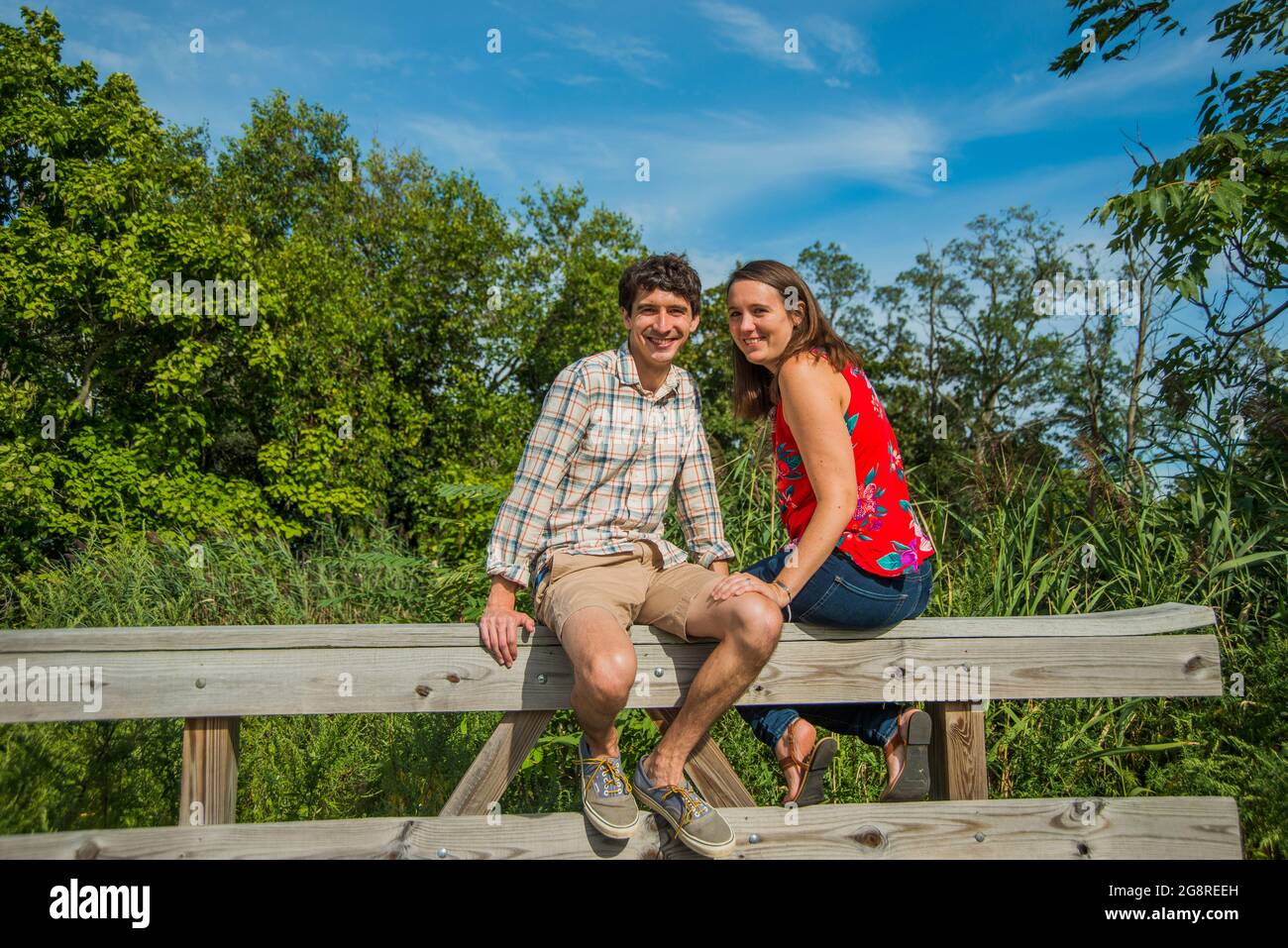 Two couple sitting on fence hi-res stock photography and images - Alamy