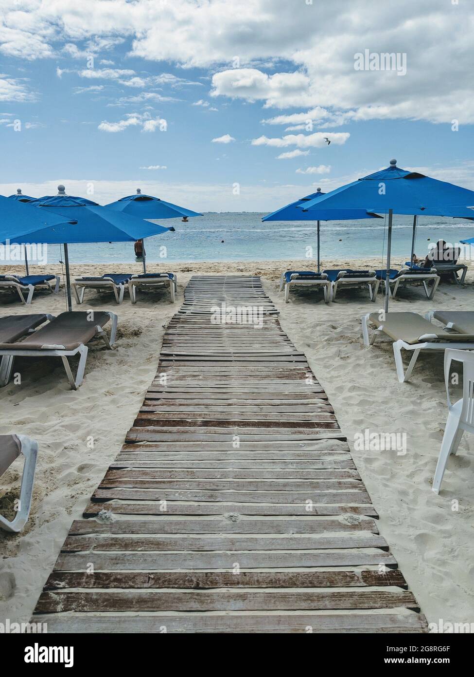 Wooden plank path on the sand beach leading to the azure sea Stock ...