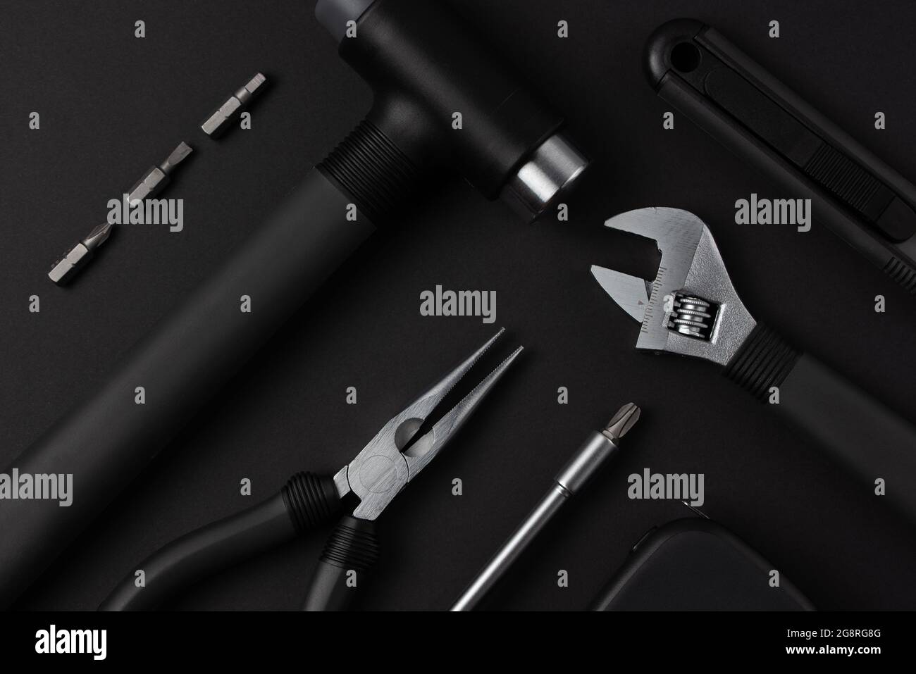 Black metal tools on black background Stock Photo - Alamy
